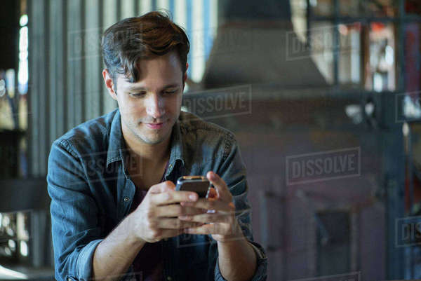 Man using smartphone - Royalty-free Stock Photo | Dissolve