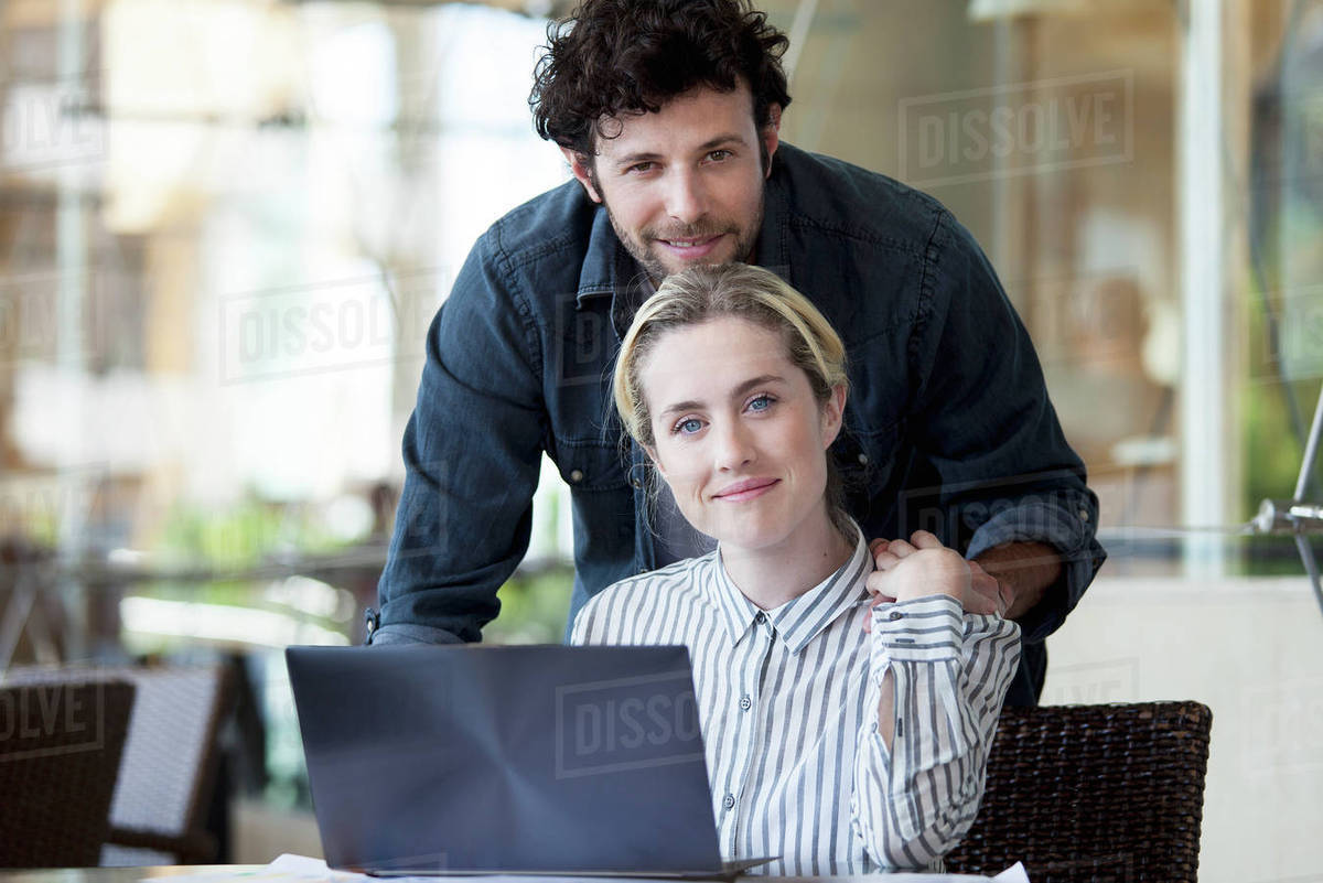Couple using laptop computer together at home - Stock Photo - Dissolve