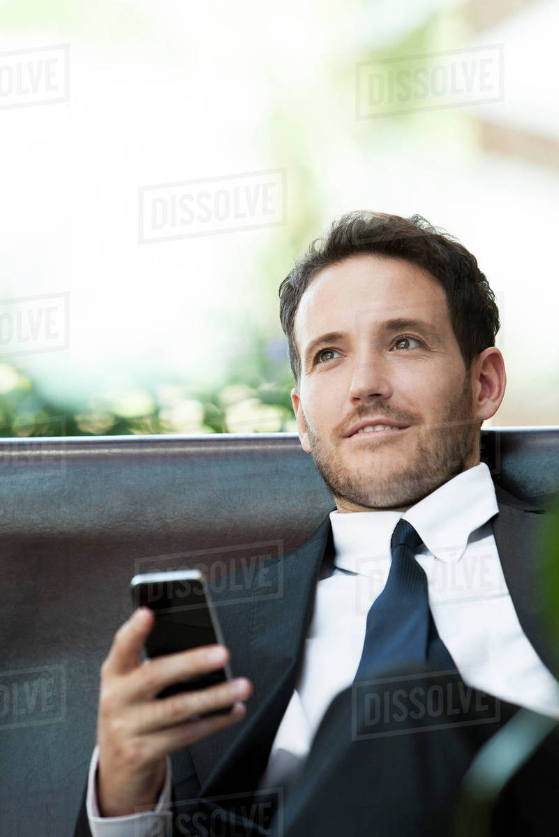 Business executive using smartphone - Royalty-free Stock Photo | Dissolve