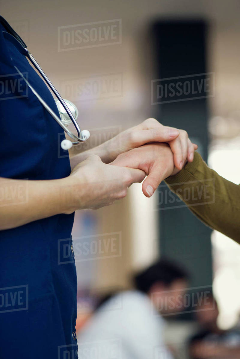 Doctor holding patient's hand - Royalty-free Stock Photo | Dissolve