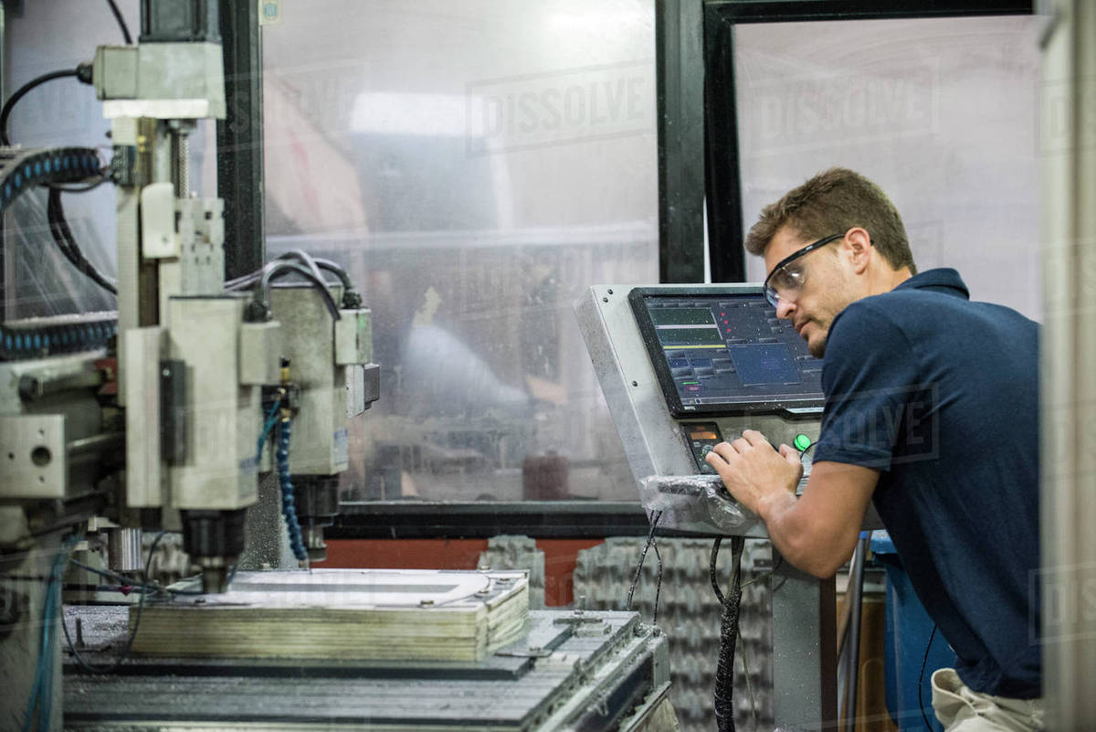 Machinist working in factory - Royalty-free Stock Photo | Dissolve