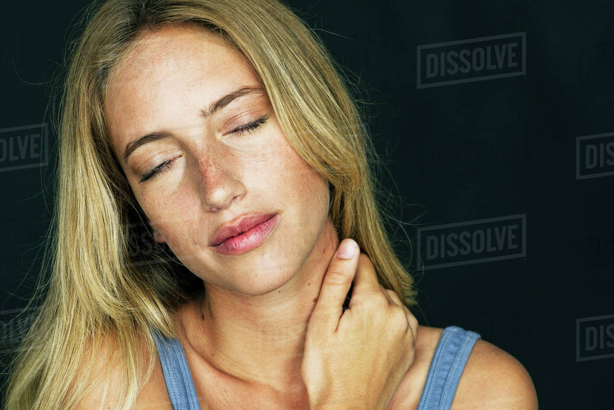 Woman massaging her neck - Stock Photo - Dissolve