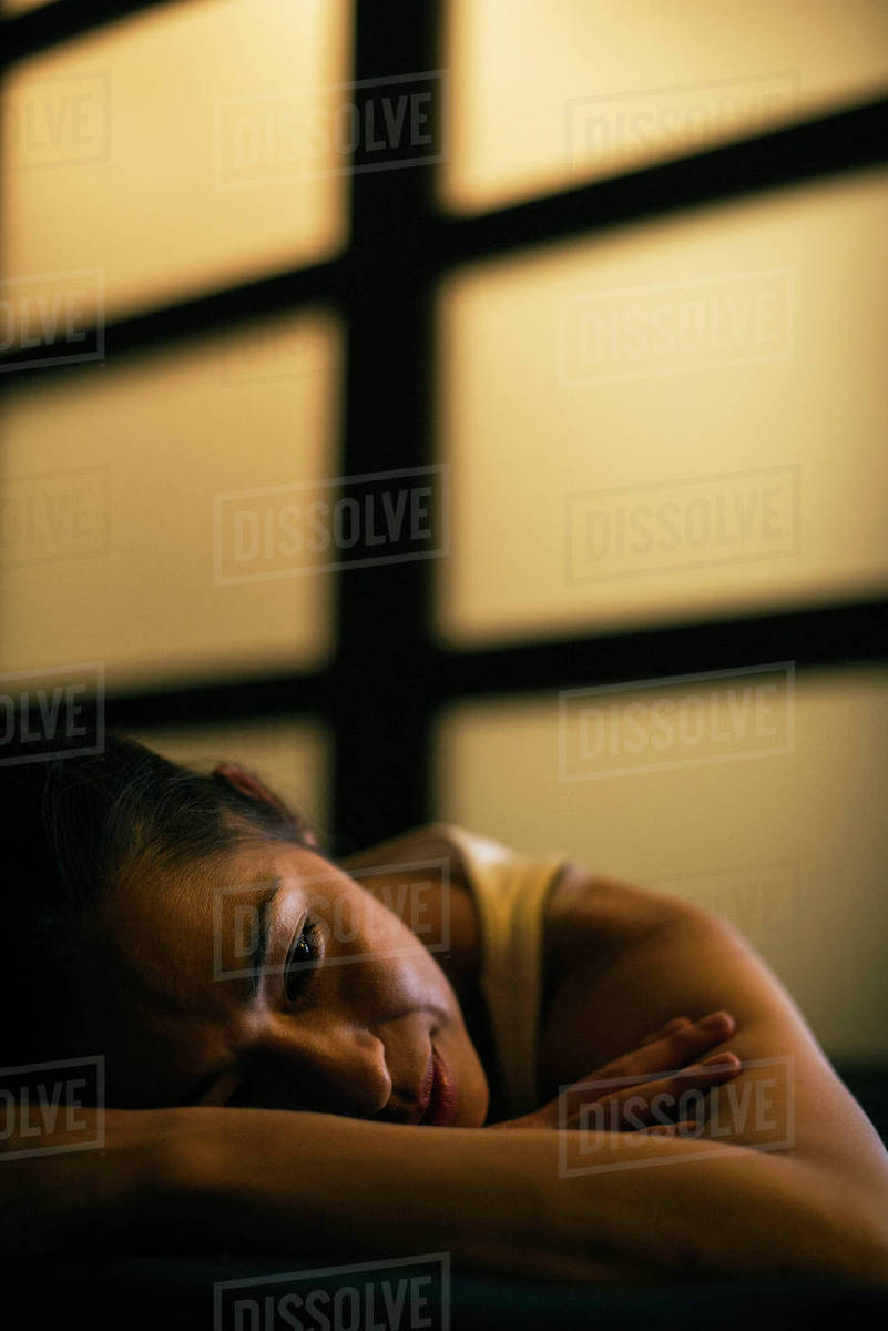 Woman resting head on arms - Royalty-free Stock Photo | Dissolve