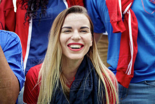 Woman watching football match, smiling cheerfully - Royalty-free Stock ...