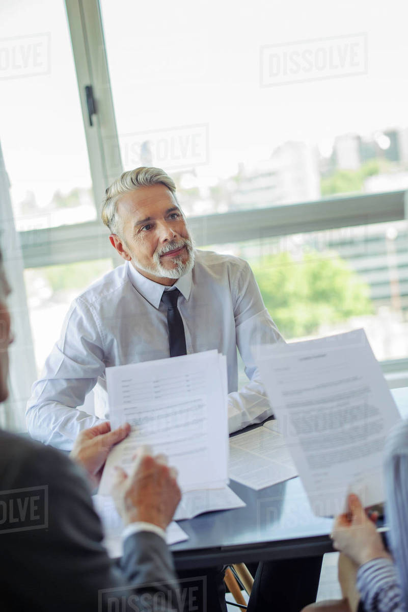 Businessman meeting with clients - Stock Photo - Dissolve