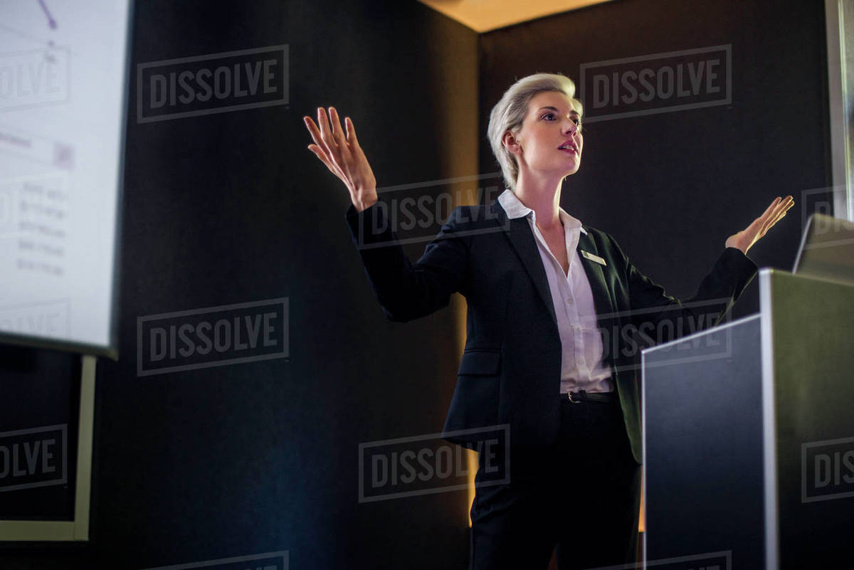 Woman giving presentation - Stock Photo - Dissolve