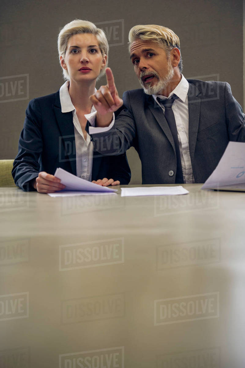 Man explaining presentation to woman - Royalty-free Stock Photo | Dissolve