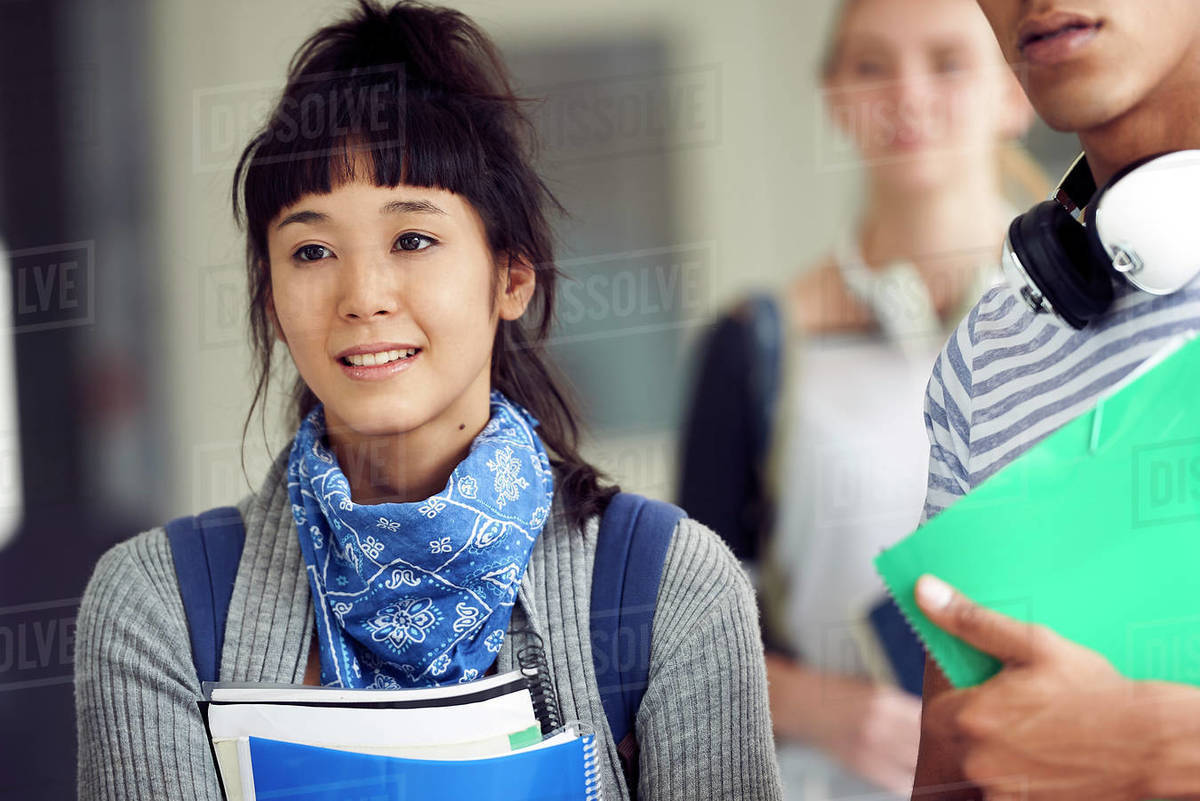 Female student smiling in corridor - Royalty-free Stock Photo | Dissolve