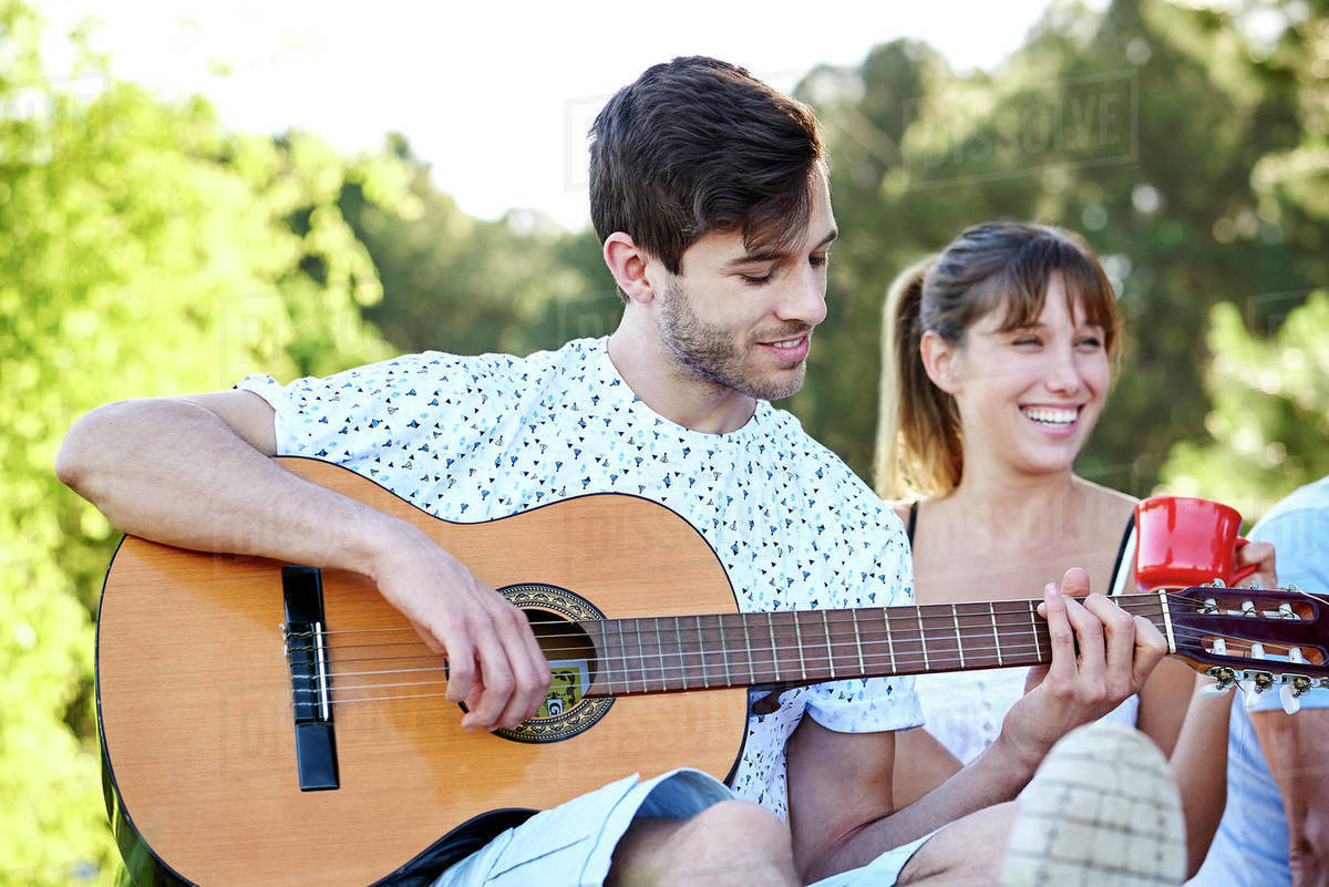 Young man playing guitar - Royalty-free Stock Photo | Dissolve