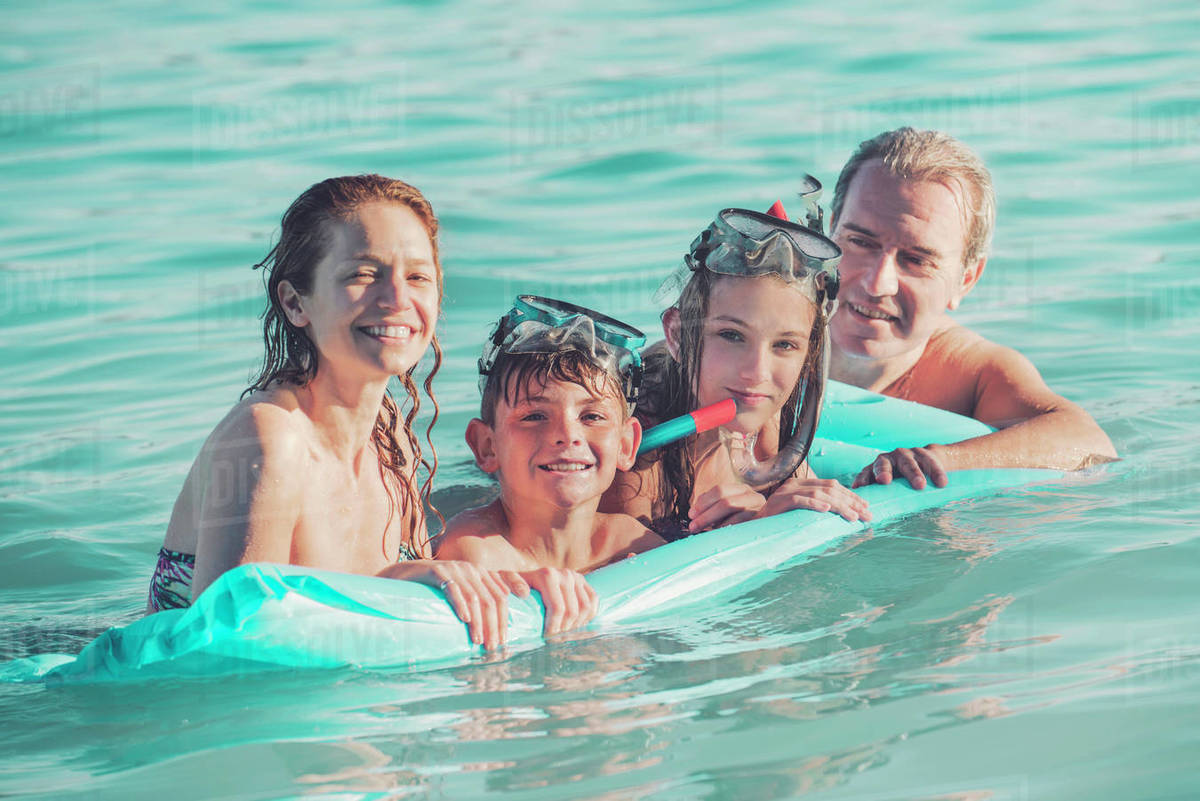 Family enjoying in swimming pool - Royalty-free Stock Photo | Dissolve
