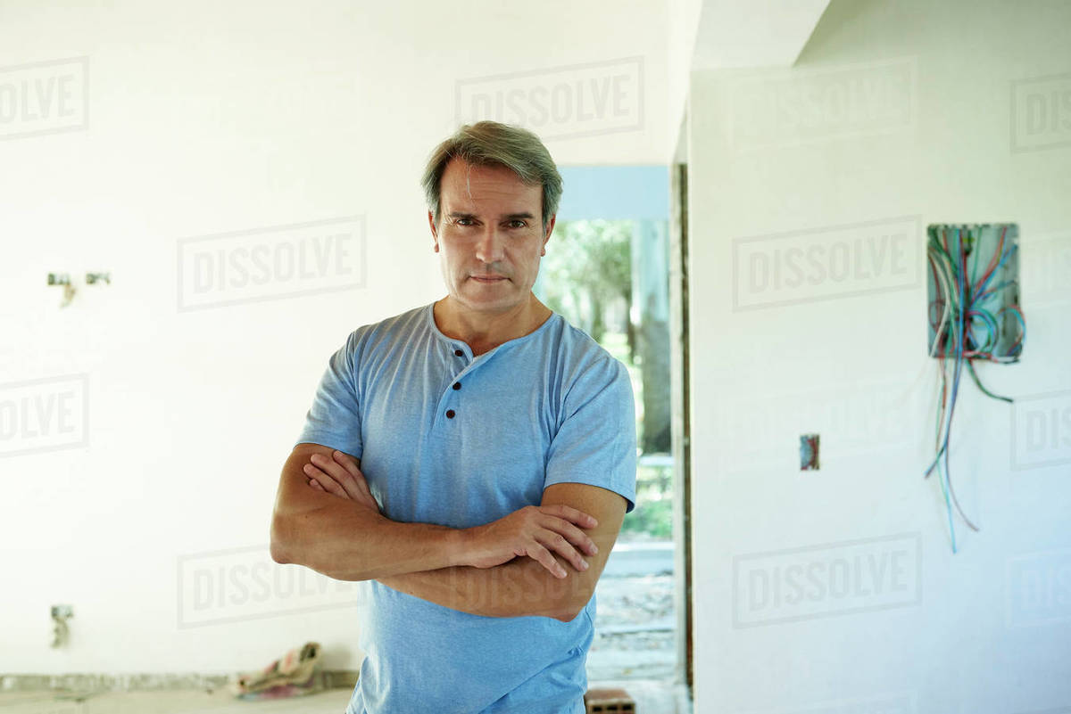 Portrait of a mature man standing indoors - Stock Photo - Dissolve