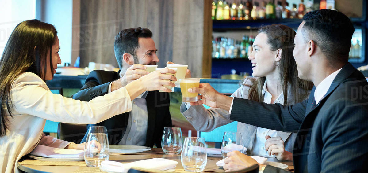 Business people toasting drink in bar - Royalty-free Stock Photo | Dissolve
