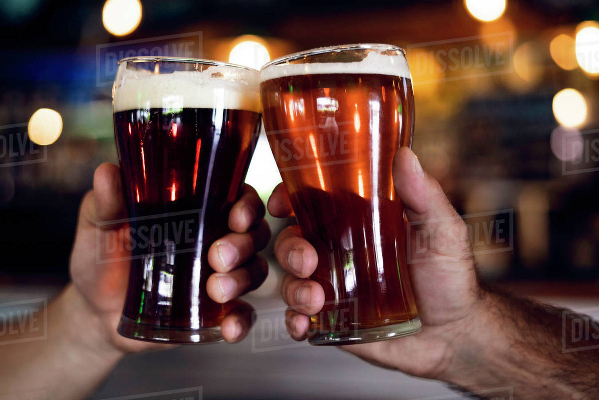 Hands toasting beer glasses - Royalty-free Stock Photo | Dissolve