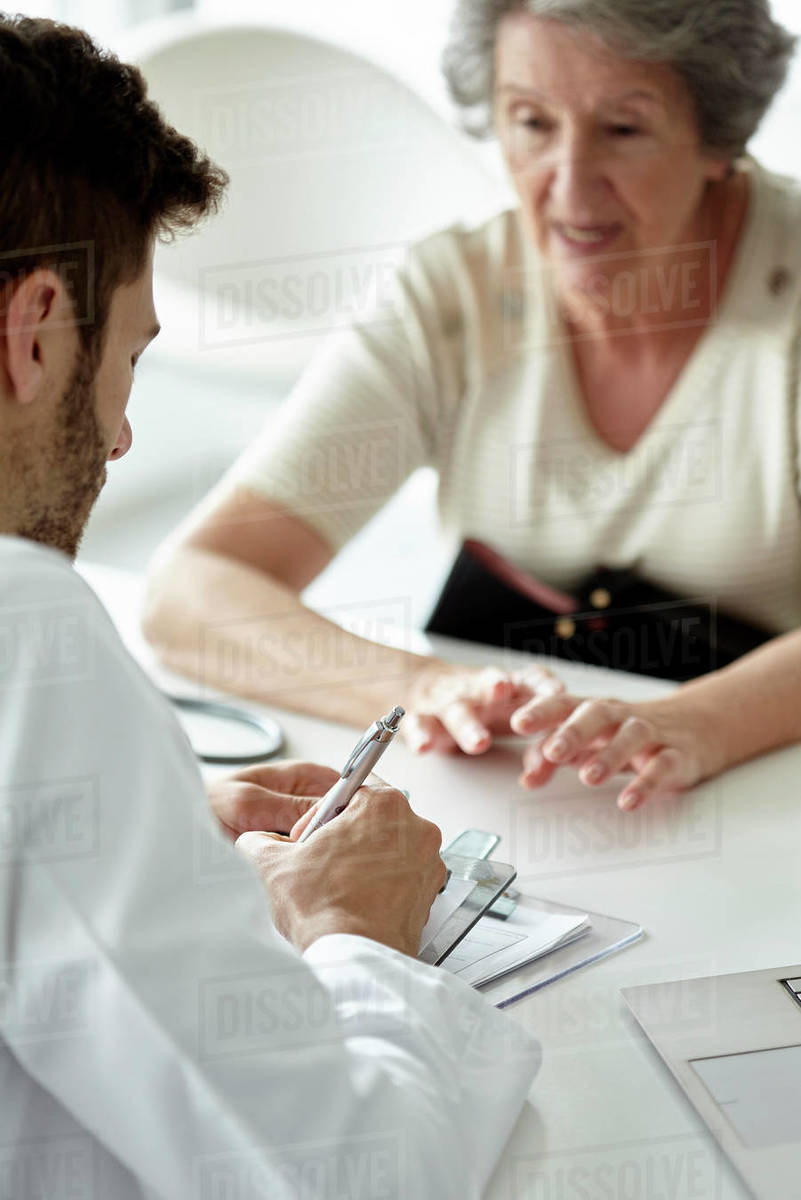 Doctor writing prescription - Royalty-free Stock Photo | Dissolve