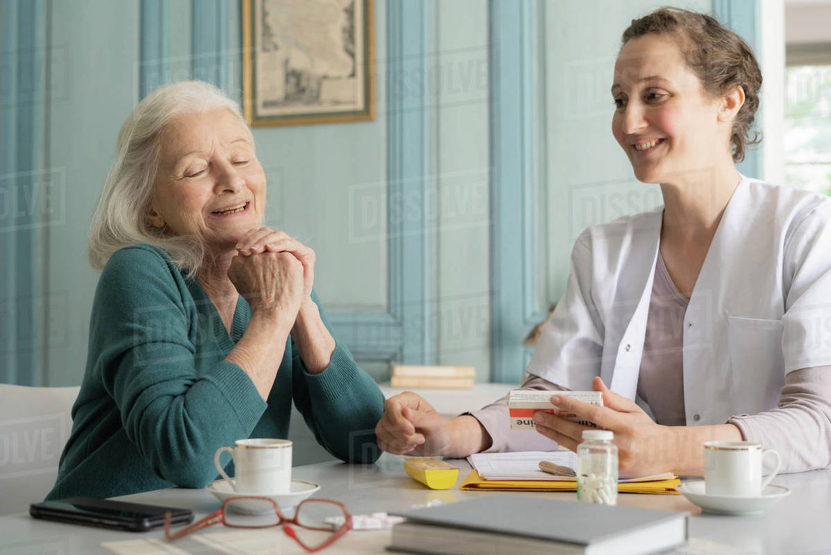 Doctor and patient sitting in clinic - Royalty-free Stock Photo | Dissolve