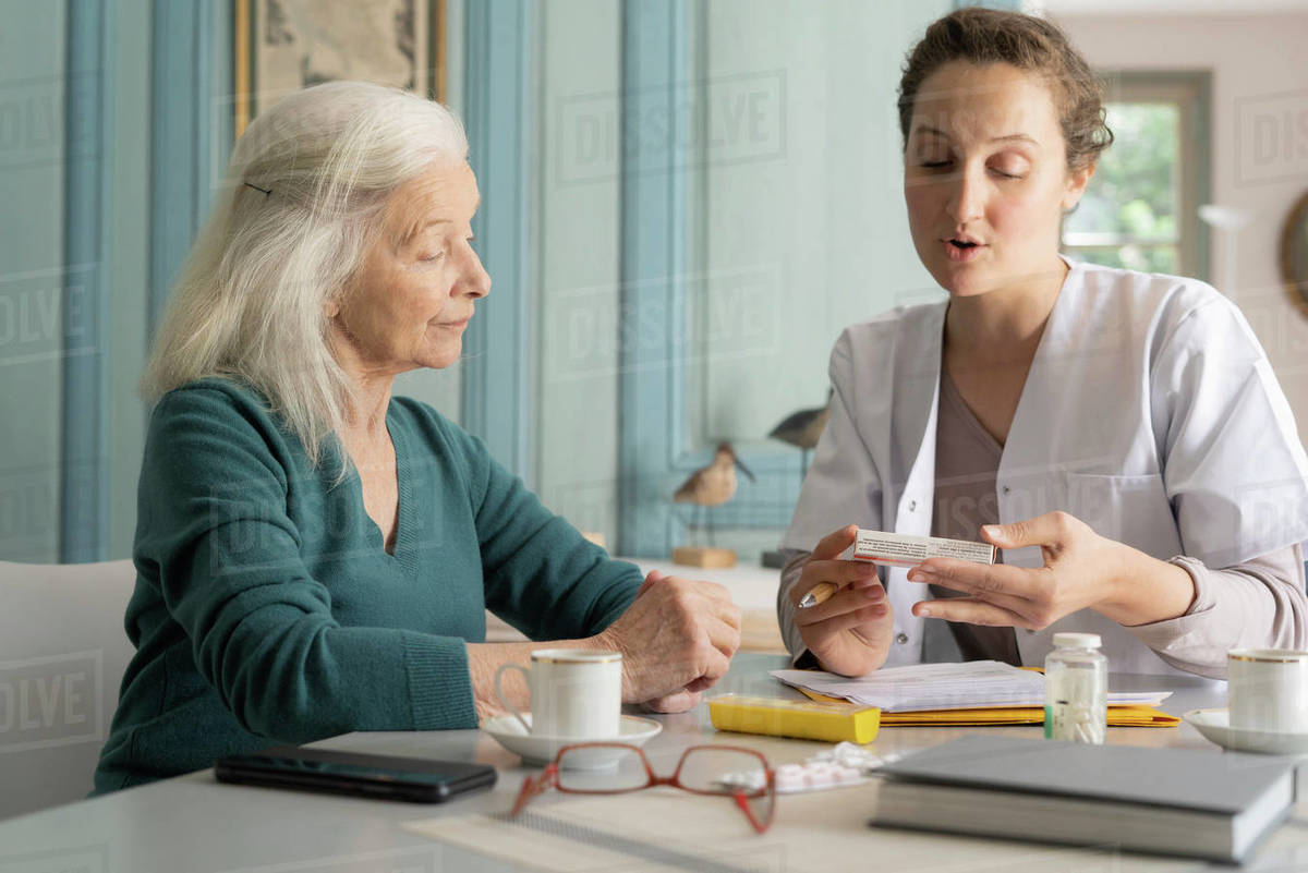Doctor explaining medicine box to patient - Royalty-free Stock Photo ...