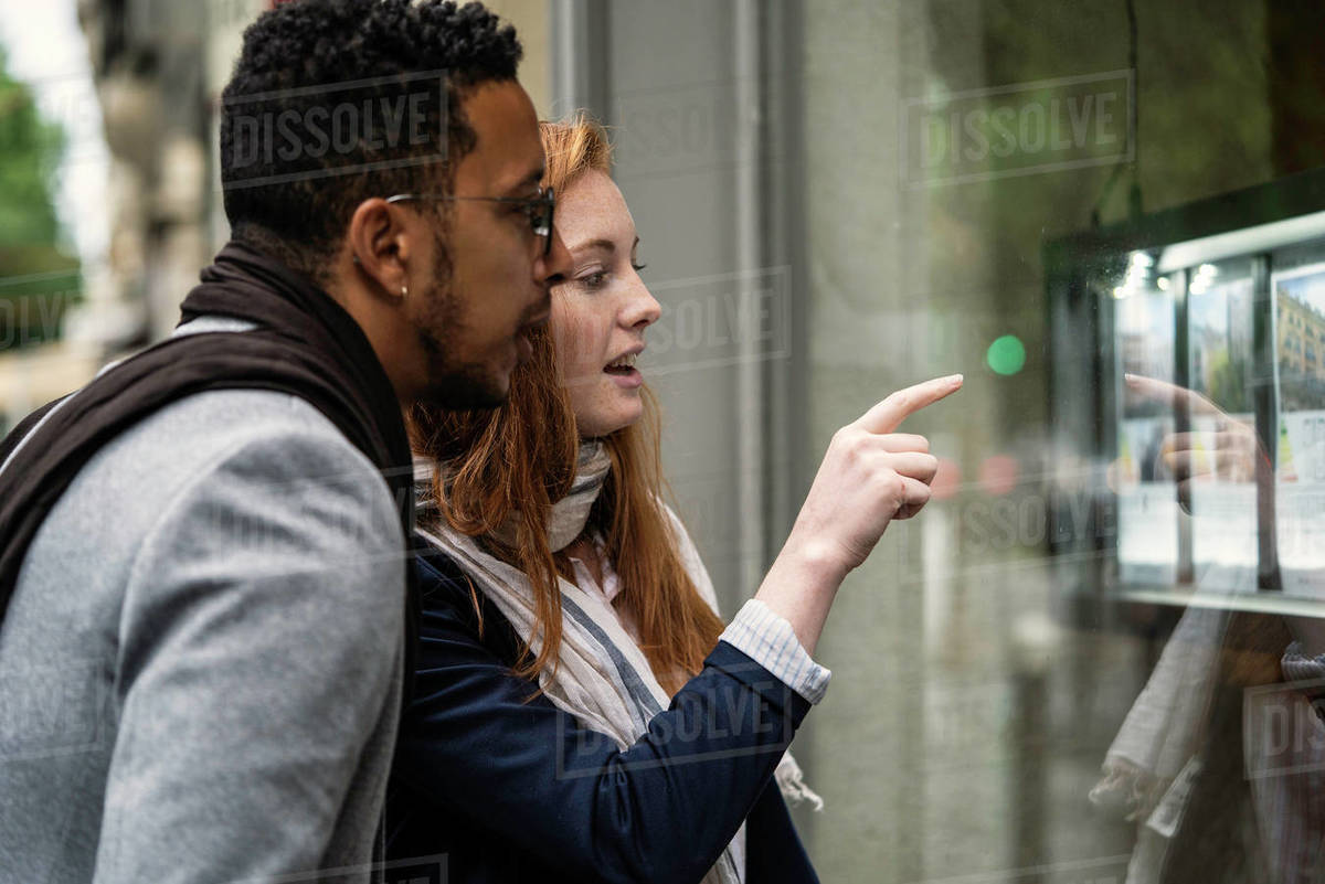Couple looking at window display - Royalty-free Stock Photo | Dissolve