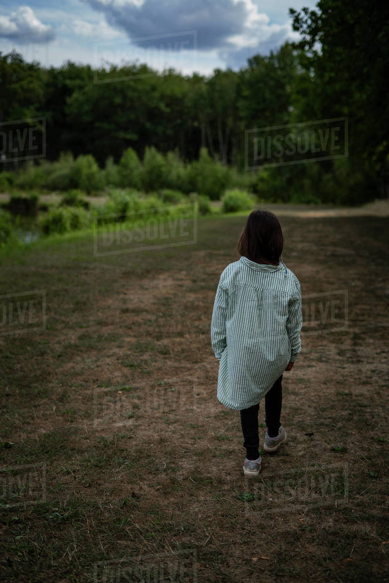 Girl walking outdoors - Royalty-free Stock Photo | Dissolve