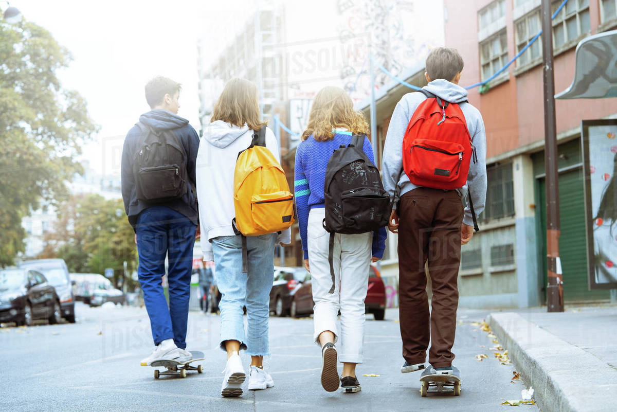 Friends walking on street - Royalty-free Stock Photo | Dissolve