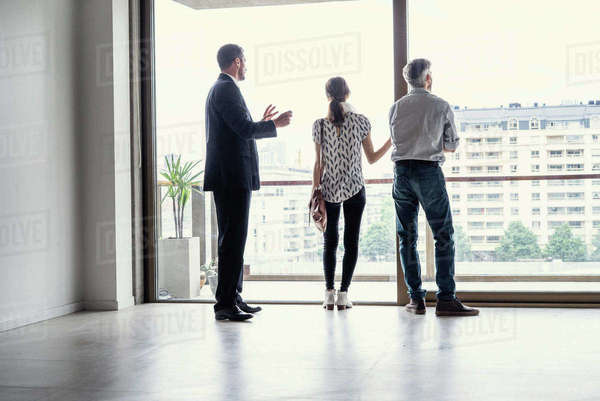 Real estate agent showing house to couple - Royalty-free Stock Photo ...