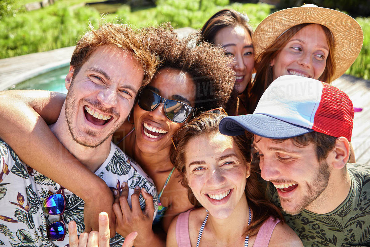 Young friends having fun at poolside - Royalty-free Stock Photo | Dissolve