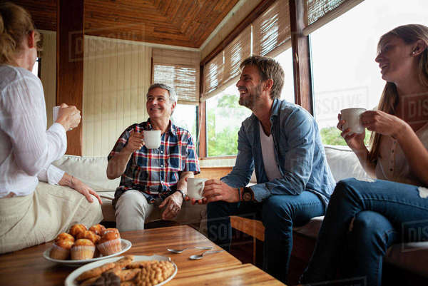 Happy family having coffee at home - Royalty-free Stock Photo | Dissolve