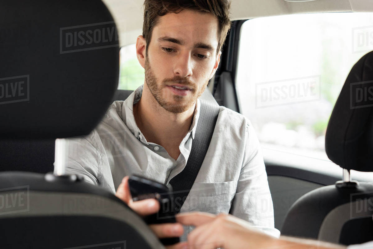 Taxi driver's hand pointing touch screen - Stock Photo - Dissolve