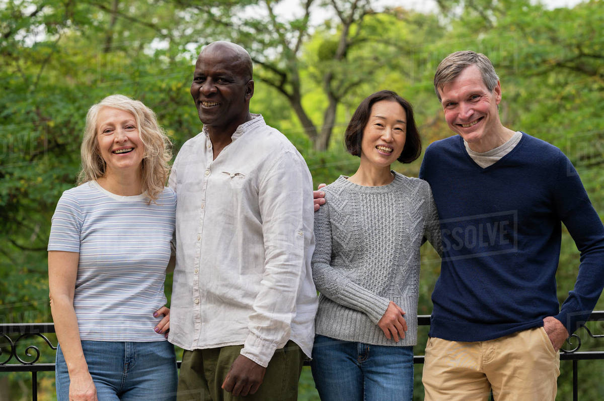 Middle-aged diverse couples hanging out in public park - Royalty-free ...