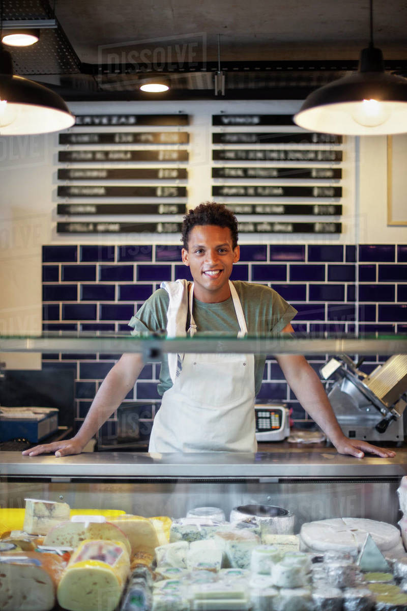 Latin American young man looking at the camera while standing behind ...