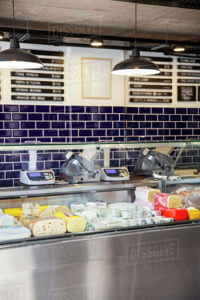 Interior view of grocery store refrigerator full of cheese - Royalty ...
