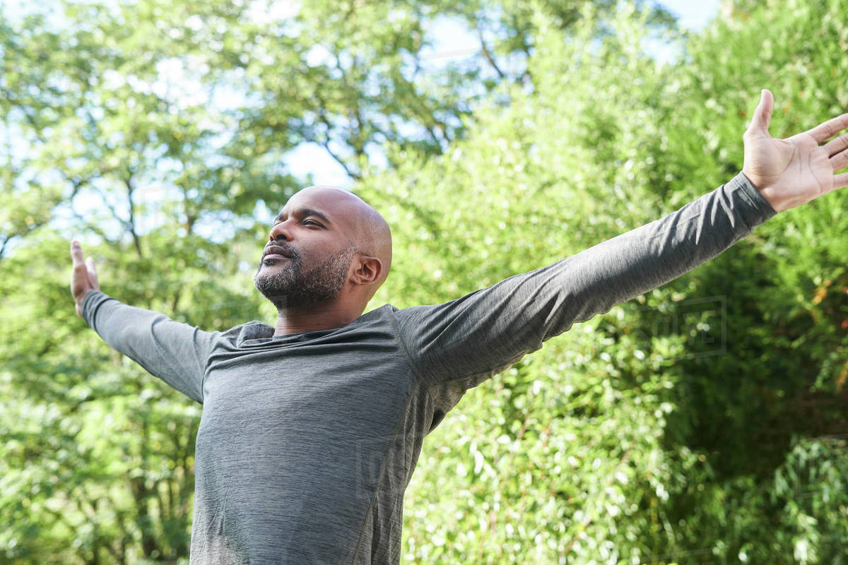 Man stretching his arms - Royalty-free Stock Photo | Dissolve
