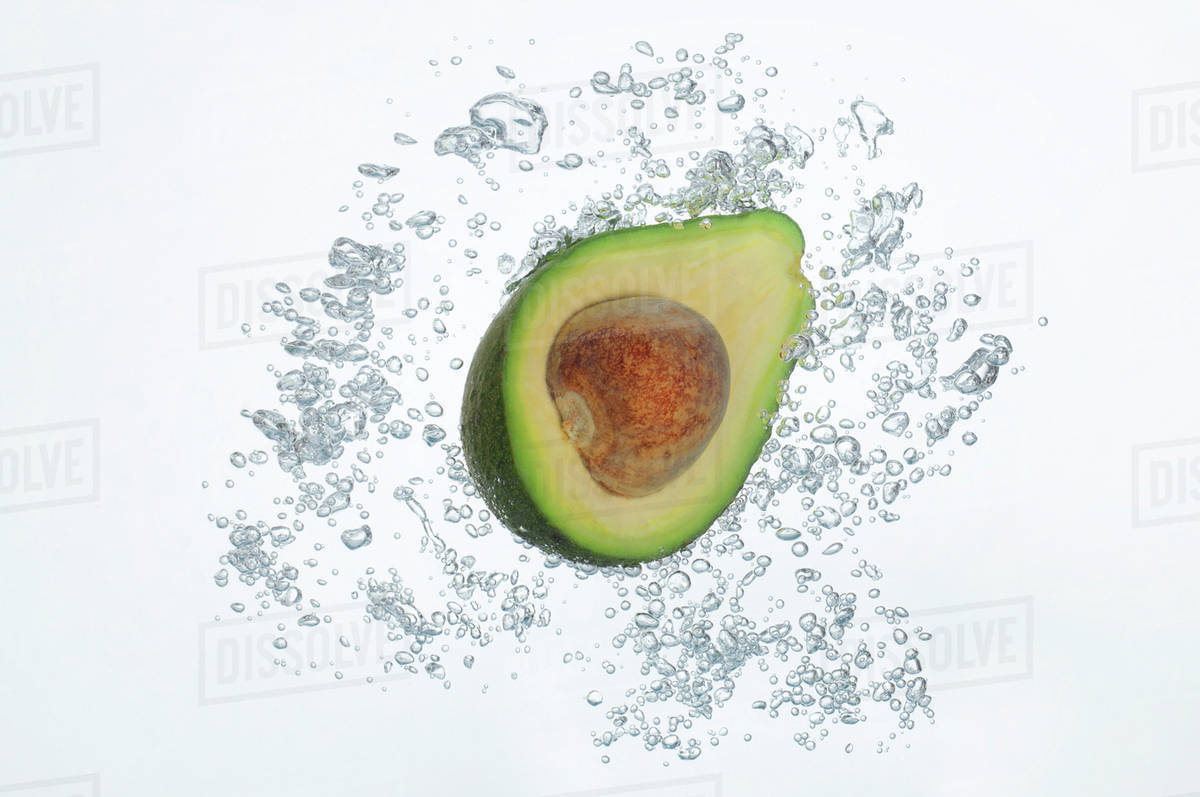 Avocado half submerged in sparkling water - Royalty-free Stock Photo | Dissolve