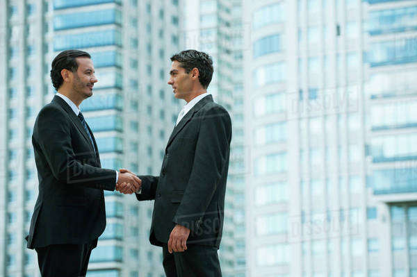 Business executives shaking hands - Royalty-free Stock Photo | Dissolve