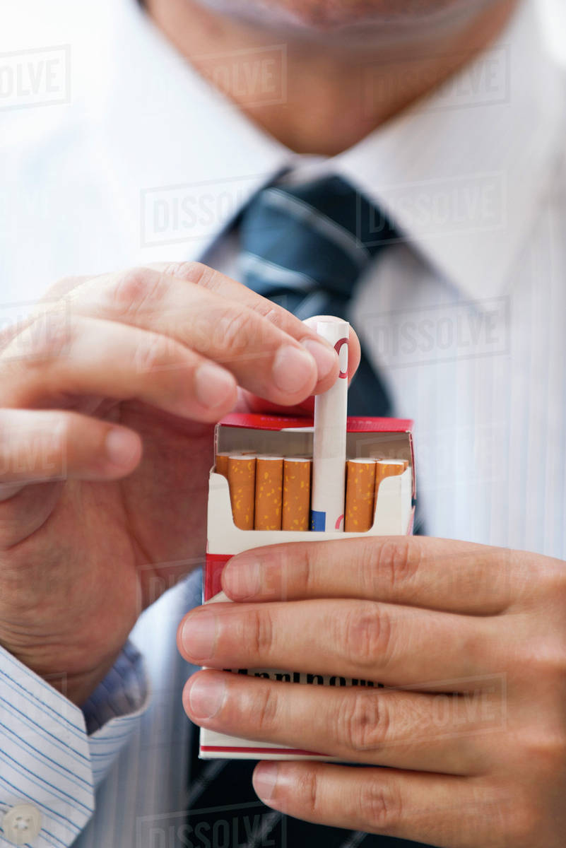 Removing rolled euro from cigarette pack - Royalty-free Stock Photo ...