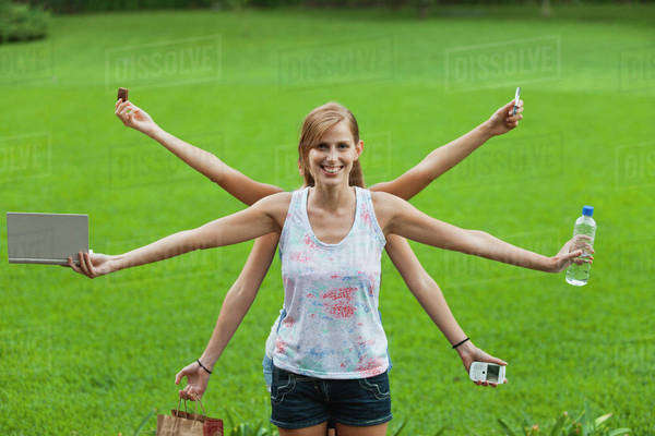 Young woman multitasking - Royalty-free Stock Photo | Dissolve