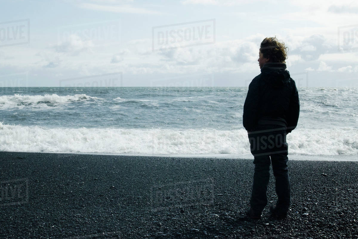 Boy looking horizon facing the sea, iceland - Royalty-free Stock Photo ...