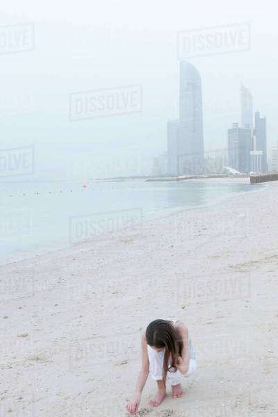 Girl looking for seashells at the beach - Royalty-free Stock Photo ...