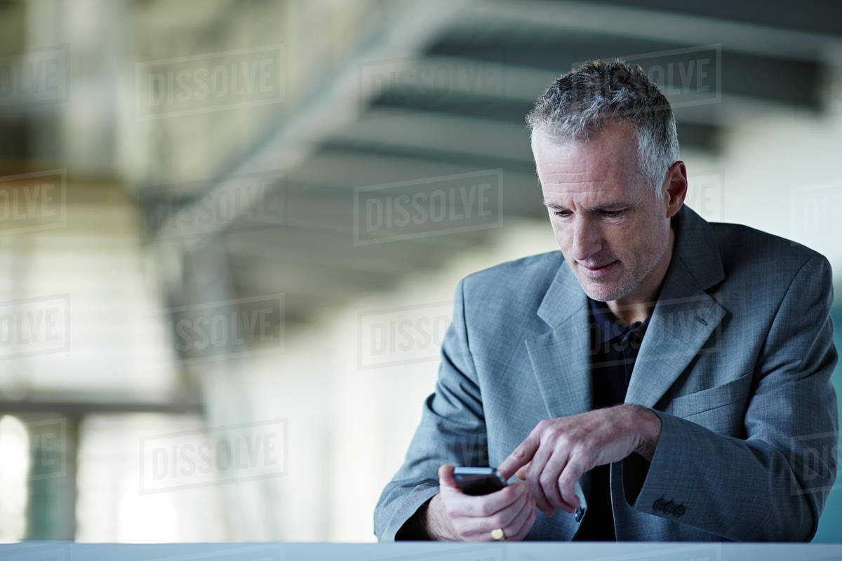 Businessman using cell phone - Royalty-free Stock Photo | Dissolve