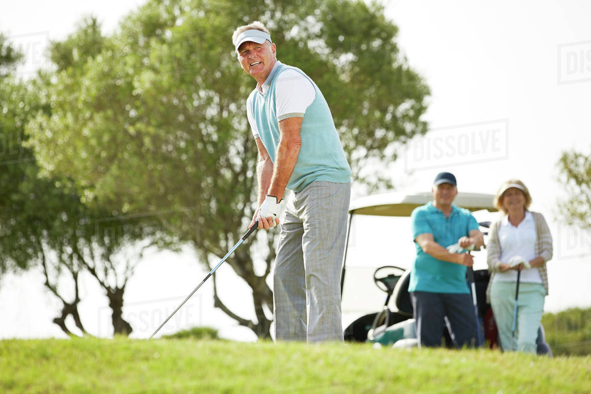 Senior friends playing golf - Royalty-free Stock Photo | Dissolve
