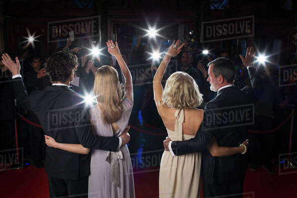 Celebrity couples waving to paparazzi on red carpet - Stock Photo ...