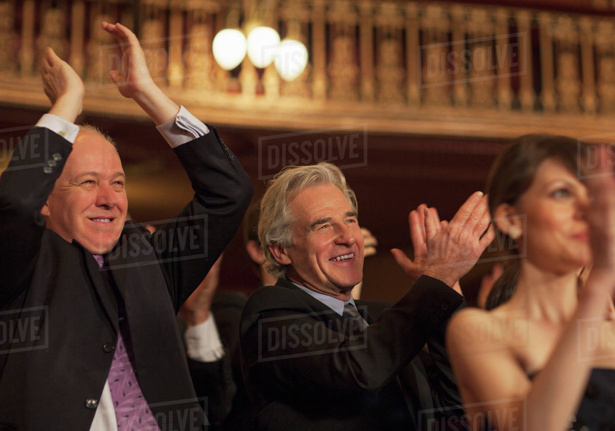 Enthusiastic men clapping in theater audience - Royalty-free Stock ...