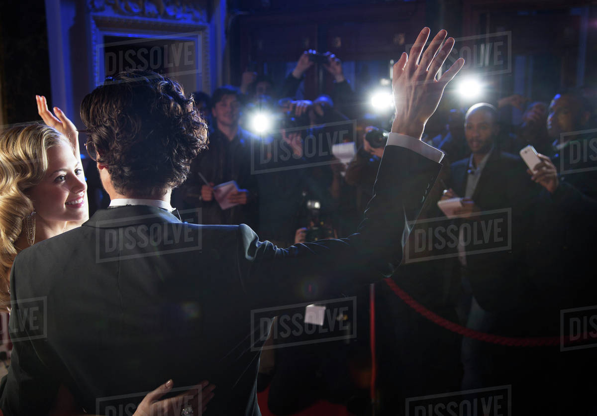 Celebrity couple waving to paparazzi at red carpet event - Stock Photo ...