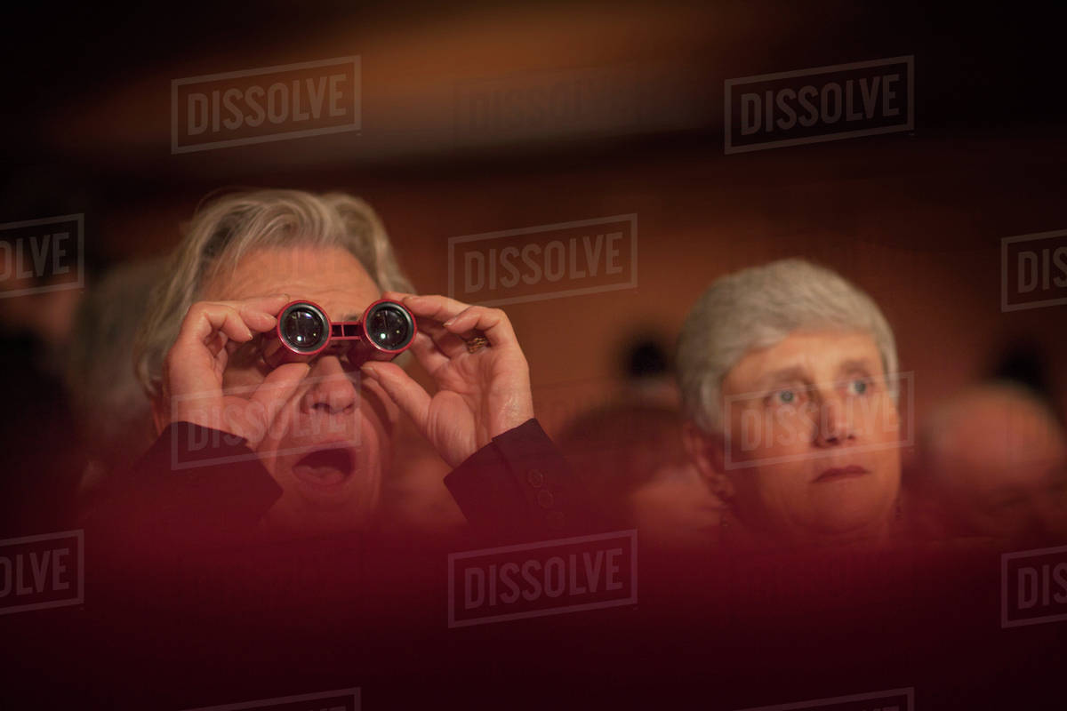Close up of man using opera glasses in theater - Royalty-free Stock ...