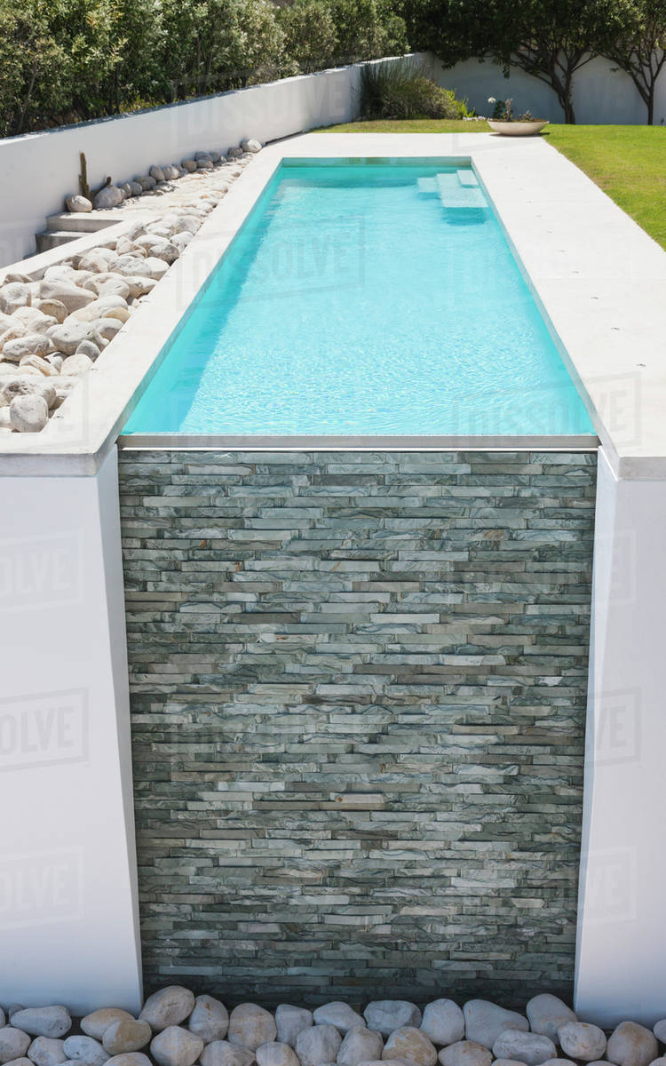 Stone wall of modern lap pool - Stock Photo - Dissolve