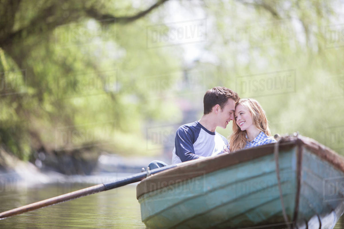 Couple sitting in rowboat on river - Royalty-free Stock Photo | Dissolve