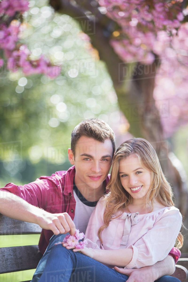 Couple hugging on park bench - Stock Photo - Dissolve
