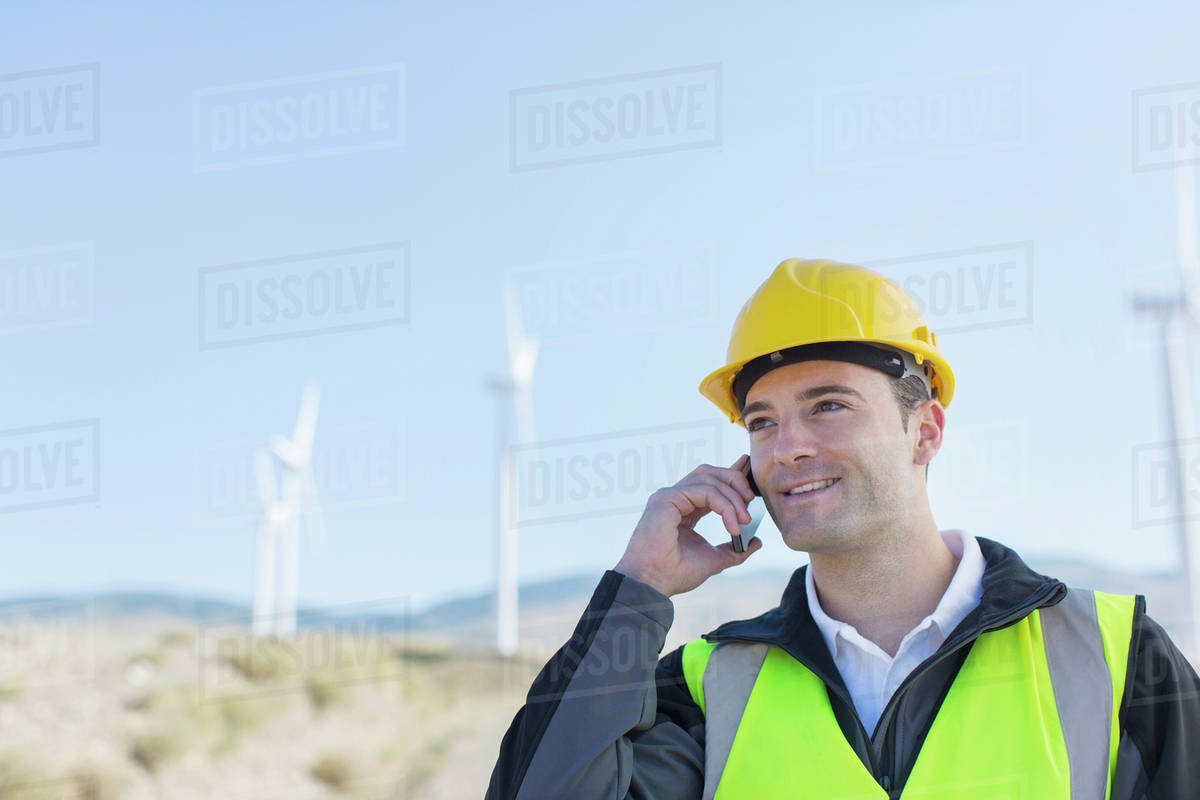 Worker using walkie talkie in rural landscape - Royalty-free Stock ...