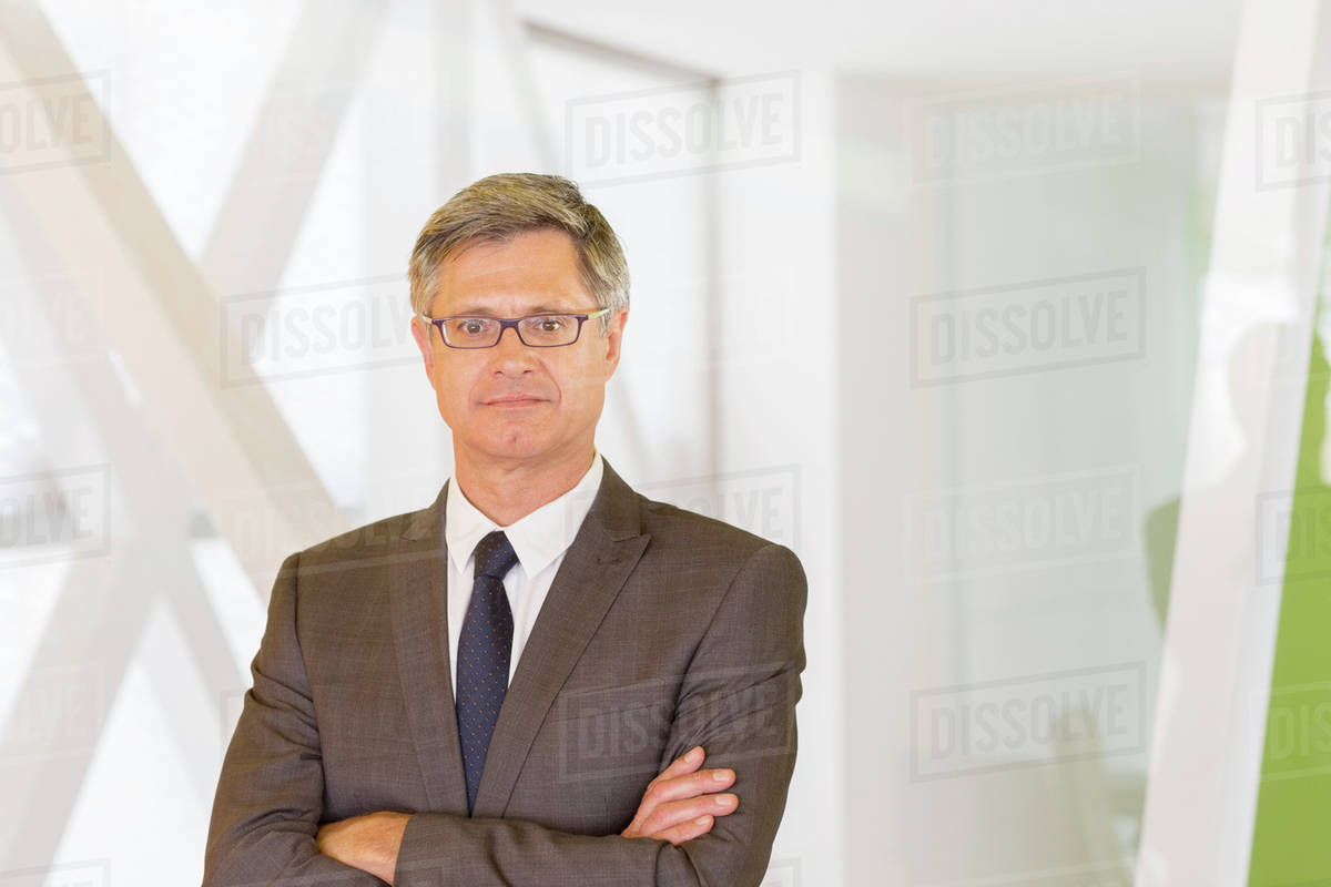 Businessman standing in office - Royalty-free Stock Photo | Dissolve