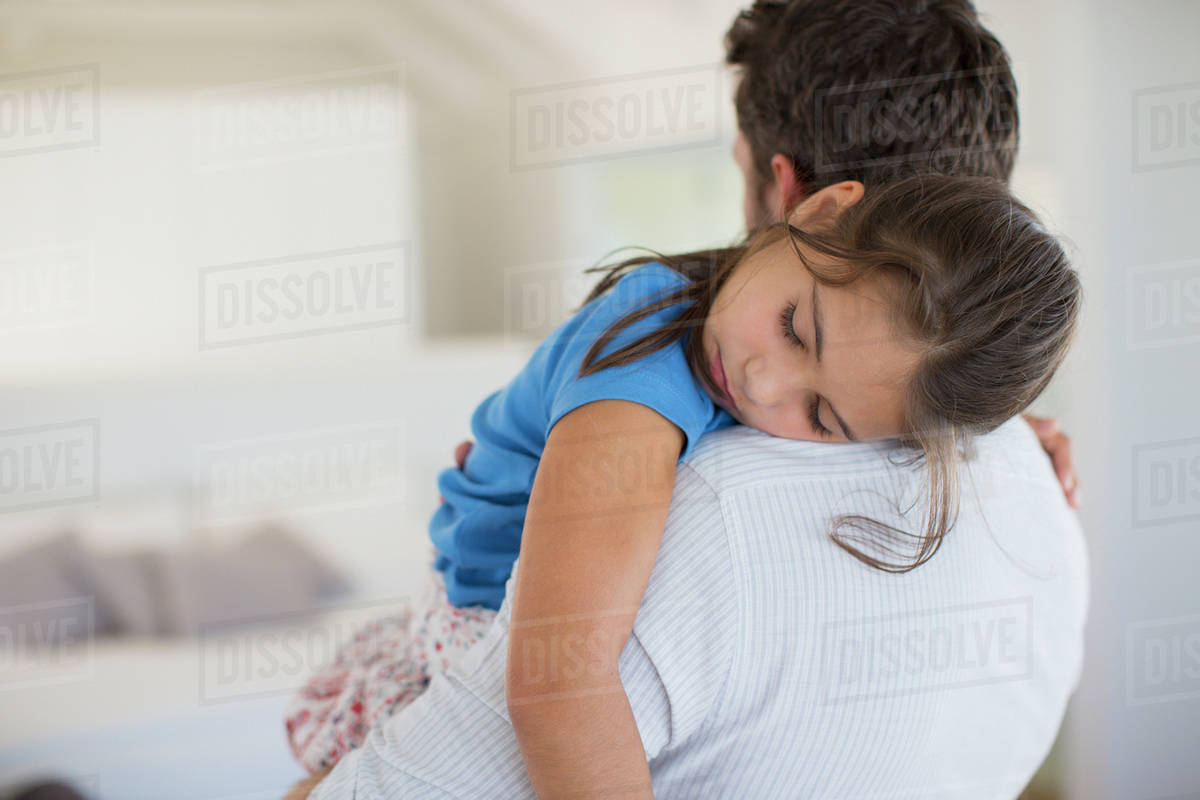 Father carrying sleeping daughter - Royalty-free Stock Photo | Dissolve