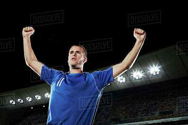 Soccer player cheering in stadium - Royalty-free Stock Photo | Dissolve